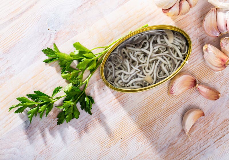 Pickled Eels in Open Tin Can with Garlic at Table, Nobody Stock Image ...