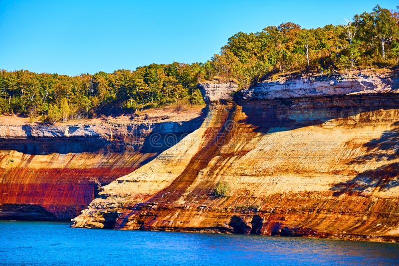 Pictured Rocks with Mostly Red and Orange Rock Surface and a Meager ...