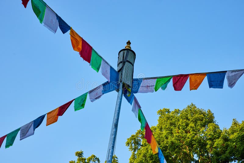 Pole with 4 Ropes Leading Off and Covered in Prayer Flags Stock Photo ...