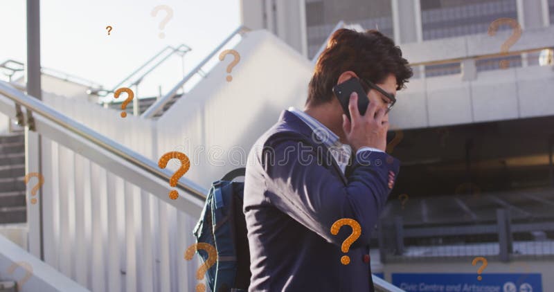 Image of Question Marks Over Asian Businessman Talking on Smartphone ...