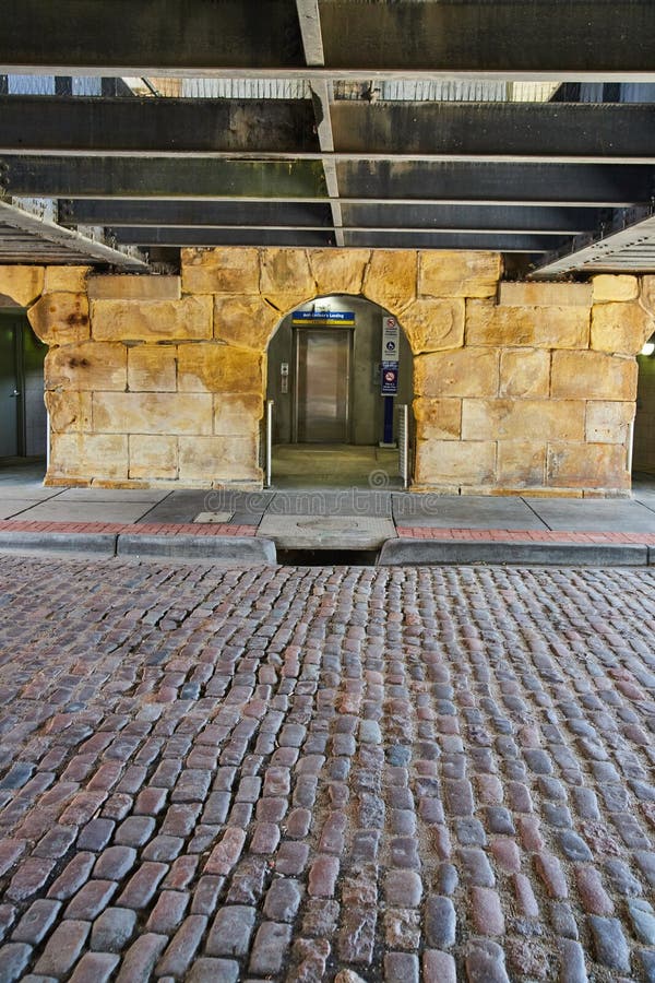 Red Brick Road Under Bridge Leading To Modern Elevator Stock Photo ...