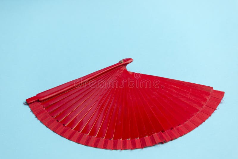 Red fan on blue background stock image. Image of summer - 170002201