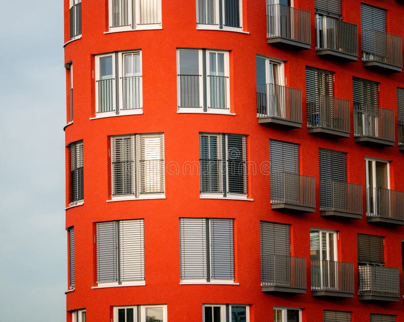 Image of Red High Rise Building with Windows and Balconies and Blinds ...