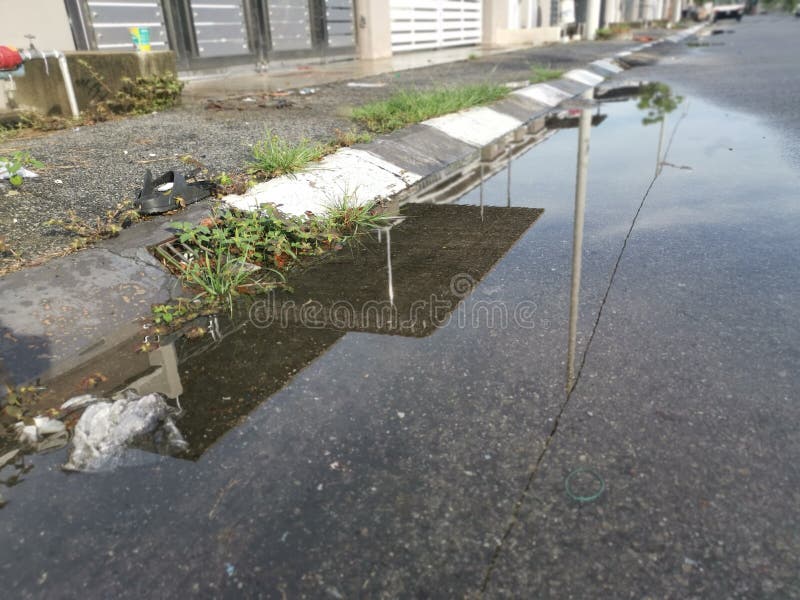Reflective Puddle with Stagnant Water on the Roadside after the Rain ...