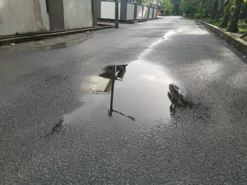 Reflective Puddle with Stagnant Water on the Roadside after the Rain ...