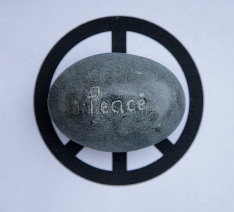 Image of a Rock Engraved with the Word Peace Over an Image of a Peace ...