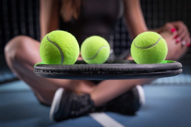 Image of a Set of Tennis Balls Lying on the Strings of a Racket. Sports ...