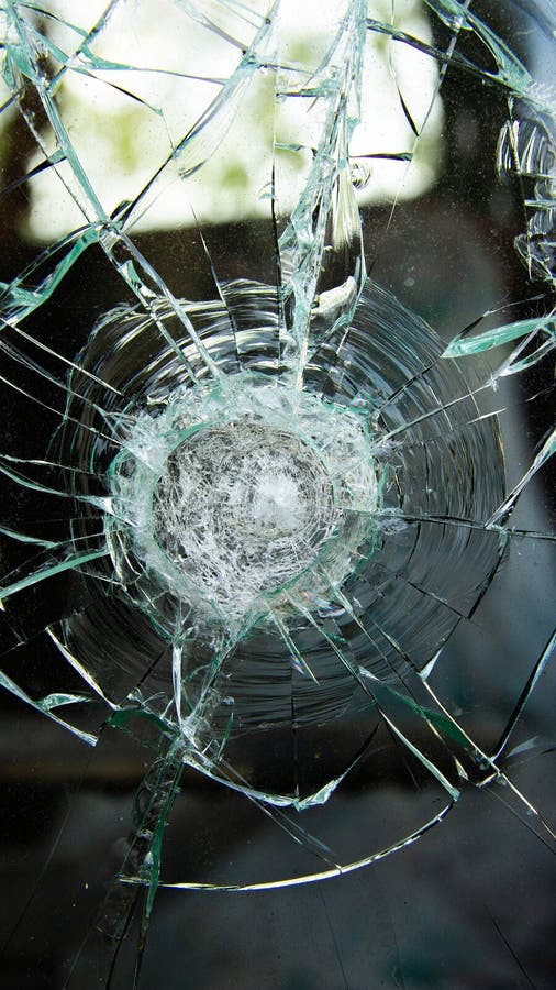 Image of a Shattered Window with a Clear Point of Impact and Radiating ...