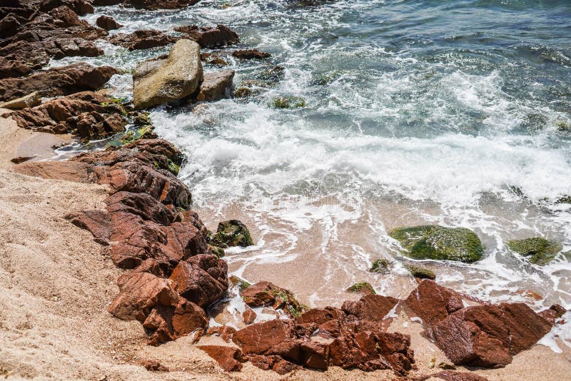 A Shore with Rocks and Sand on a Mediterranean Beach Stock Photo ...