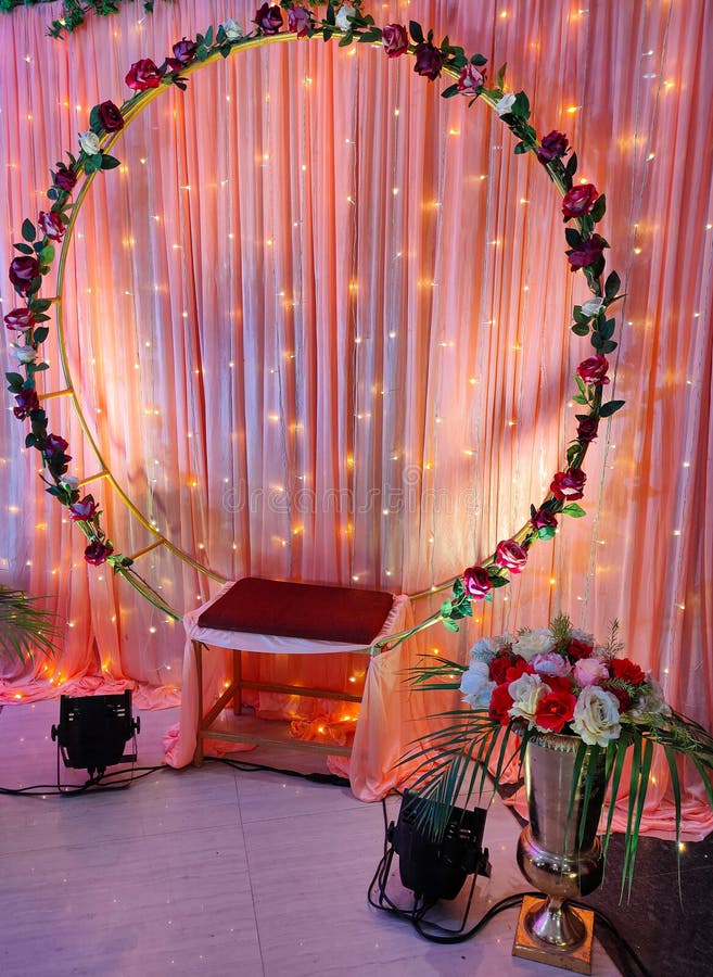 A Floral Circle Frames a Seat, Soft Drapes and Lights Create an Elegant ...