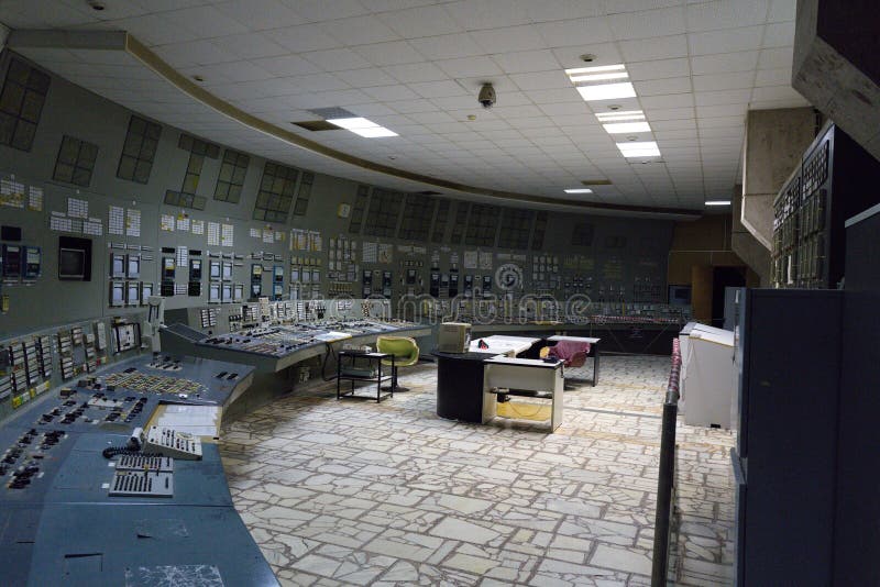 A Large Control Room with a Table and Various Electronics on the Wall ...