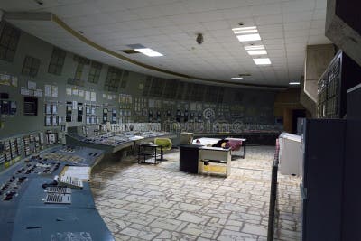 A Large Control Room with a Table and Various Electronics on the Wall ...