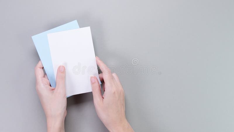 Slender Female Hands Holding Blank Note Cards on a Solid Gray ...