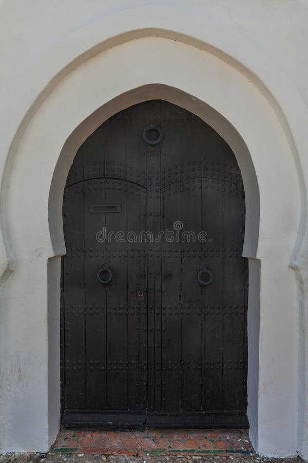 The Image Showcases a Weathered Wooden Door with an Arched Frame ...
