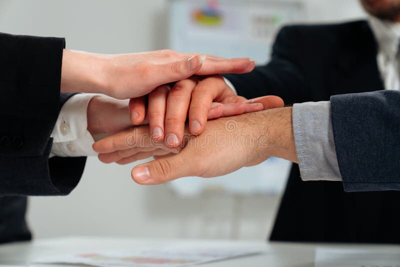 Multiple Hands Joining Together in a Business Teamwork Gesture Stock ...