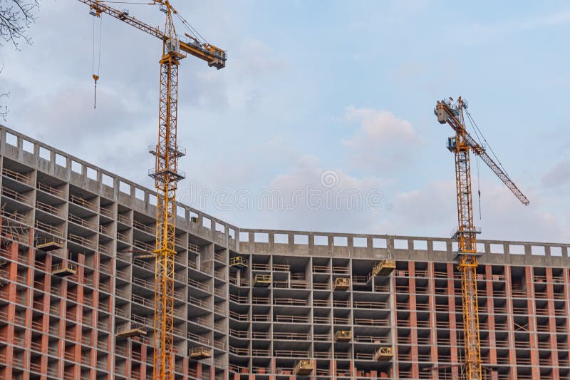 Image Shows an Active Construction Site with Cranes, Mid-construction ...
