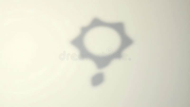 A Blurry Shadow of a Gear Like Shape with a Small Blob Underneath on a ...