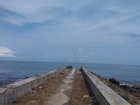 The Image Shows a Breakwater or Pier Structure Extending into the Sea ...