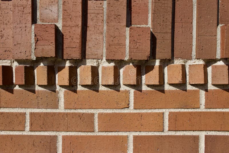 Brown Brick Wall Texture Background with Header of Protruding Bricks in ...