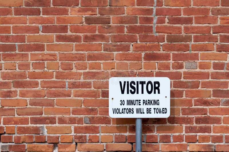 Antique Red Clay Brick Wall with Visitor Parking Sign Stock Image ...