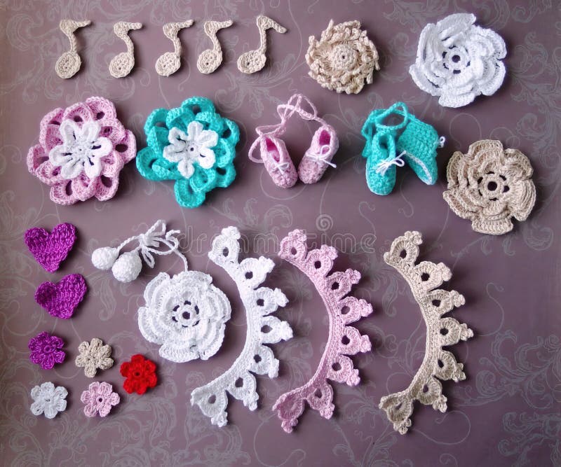 Crocheted Baby Accessories on a Purple Background Stock Images Stock ...