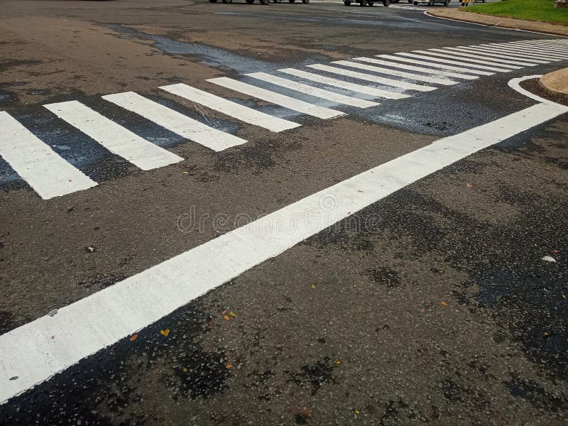 This Image Shows a Crosswalk at an Intersection, Marked by Thick White ...