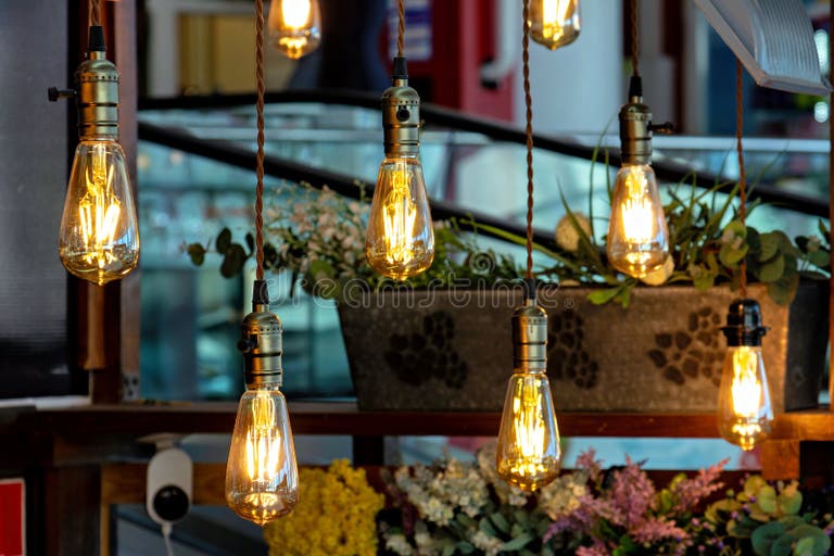 A Bunch of Light Bulbs Hanging from the Ceiling in a Restaurant Stock ...