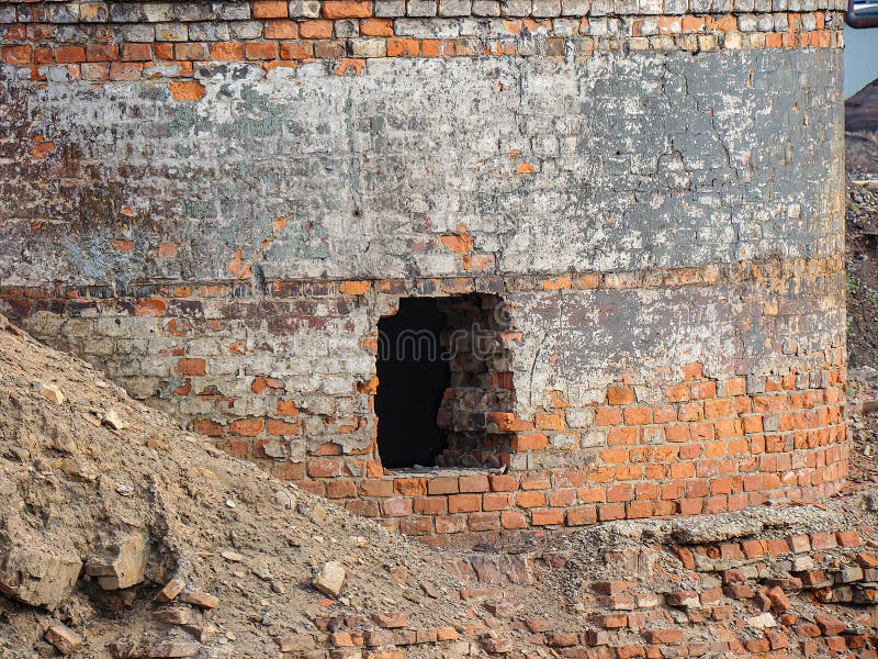 The Image Shows a Dilapidated Brick Structure with an Arched Opening ...