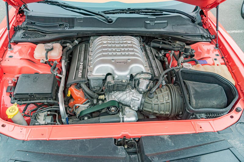 Image Shows the Dirty, Open Hood of a Red Car with a V6 Engine the ...