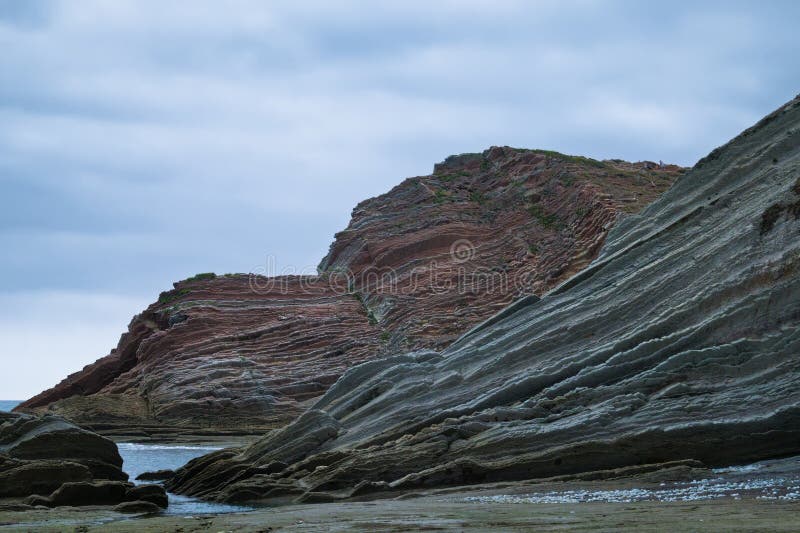 This Image Shows Dramatic, Layered Rock Formations Along the Rugged ...