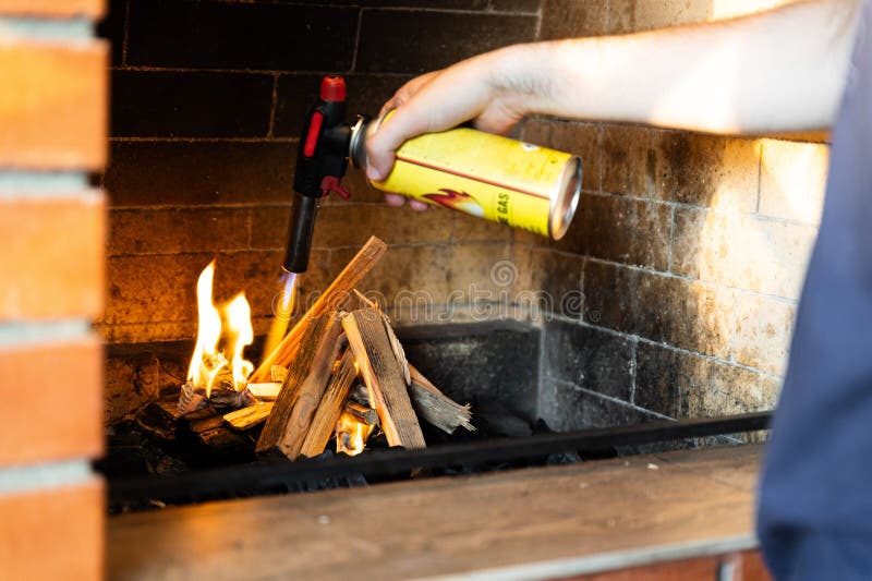 This Image Shows a Fireplace Being Lit Using a Butane Torch. the Flame ...