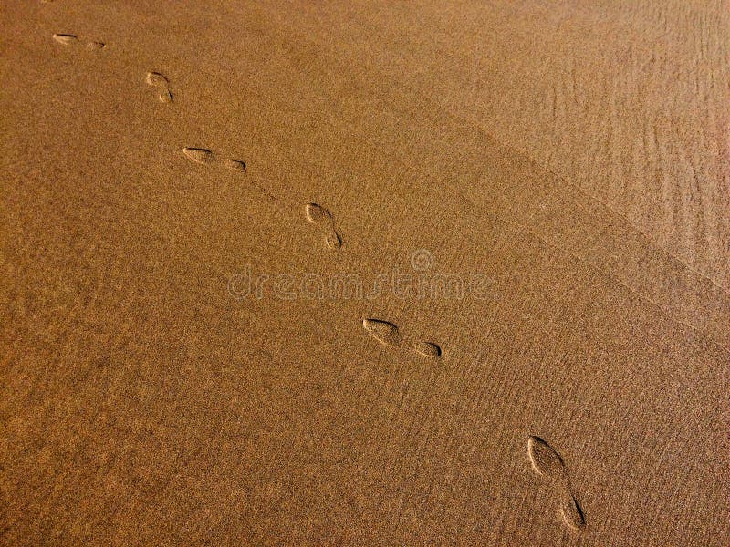 The Image Shows Footprints on a Sandy Surface, Indicating a Path Stock ...