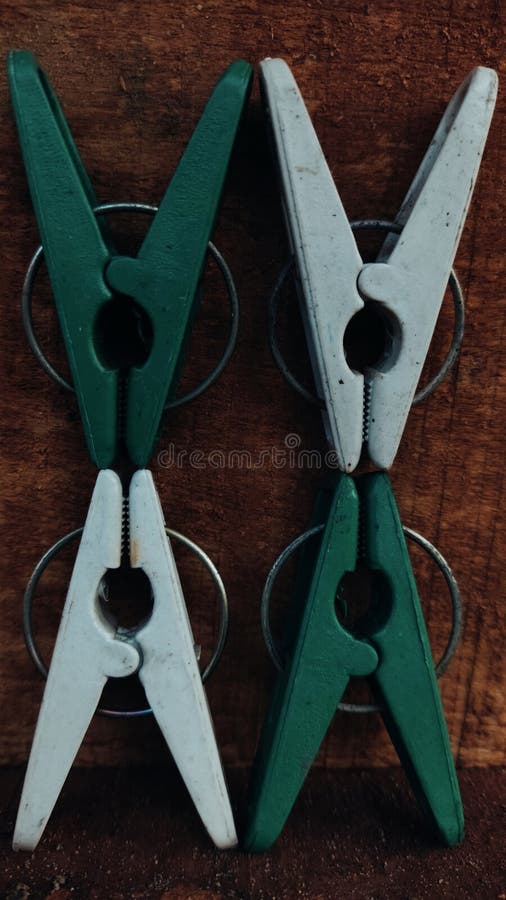 The Image Shows Four Clothespins Arranged in a Two-by-two Grid on a ...
