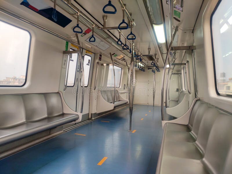 The Image Shows a Modern Metro Train Interior with Grey Upholstered ...