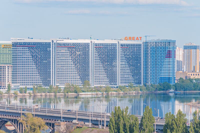 Image Shows a Modern, Multi-storied Building with Reflective Water ...