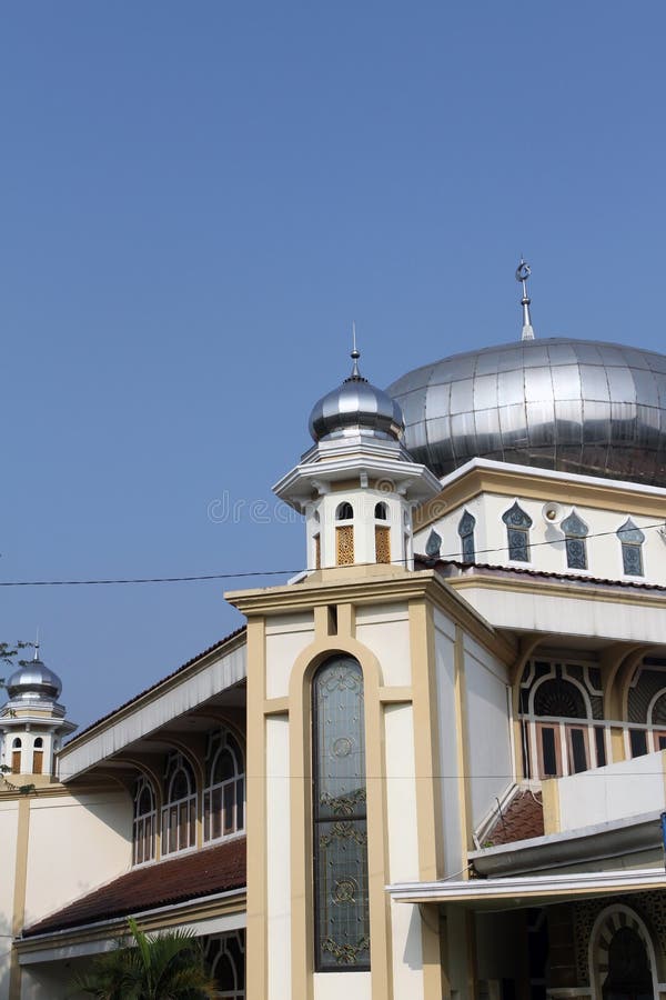 The Image Shows a Mosque with a Large Silver Dome and Smaller Minarets ...