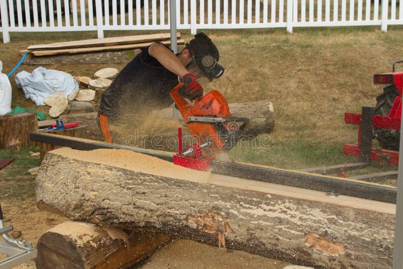 A Log Being Planked Using a Chain Saw. Editorial Photo - Image of ...