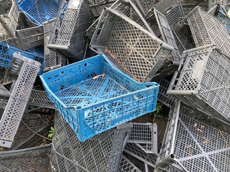 Image Shows Stacked Plastic Baskets Blue and Gray Outdoors, Possibly on ...