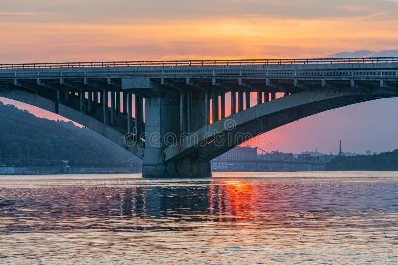 Image Shows a Striking Sunset View of a Suspension Bridge with Multiple ...