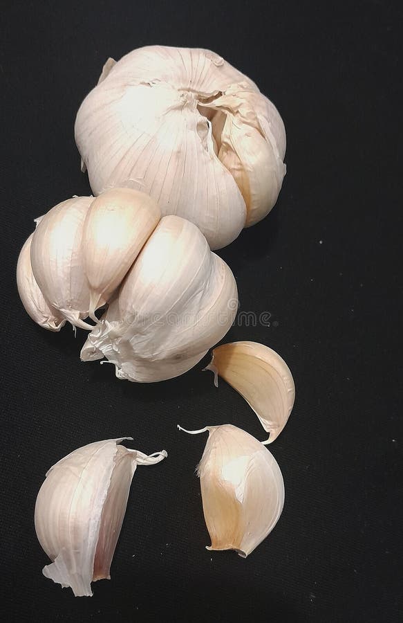 This Image Shows Two Whole Garlic Bulbs and Three Individual Cloves on ...