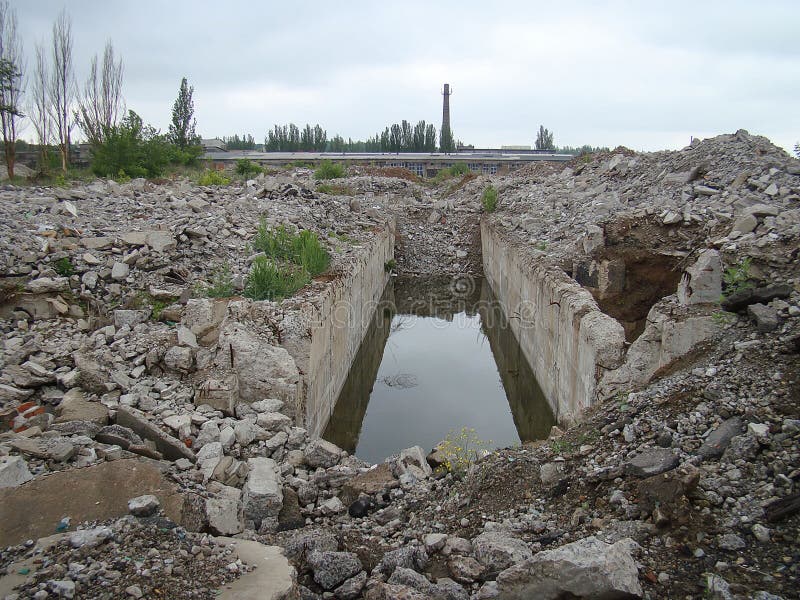 Image Shows an Urban, Decayed Area with a Littered Canal and ...