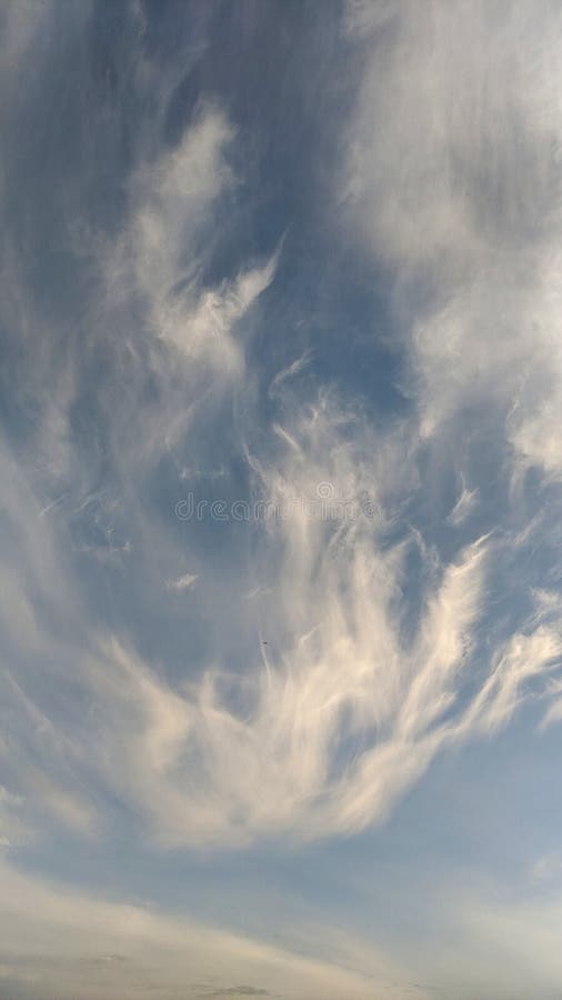 The Image Shows a Vast Expanse of Sky Filled with Wispy Clouds. the Clouds Create Intricate ...