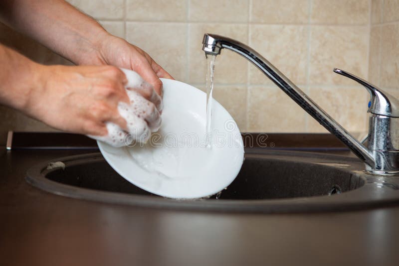 Image of Side of Man Washing White Plates Stock Photo - Image of ...
