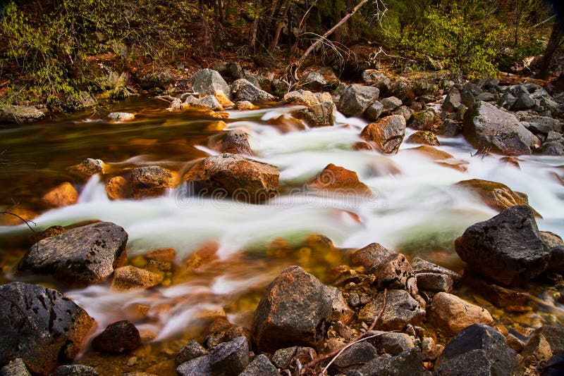 Side Profile of River with Water Cascading Over Rocks Stock Photo ...