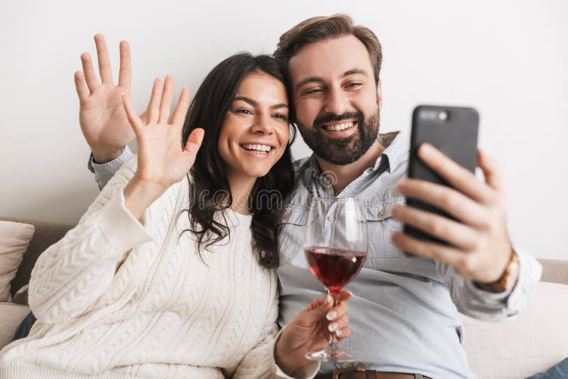 Image Of Smiling Couple Taking Selfie Photo Together On Sofa While