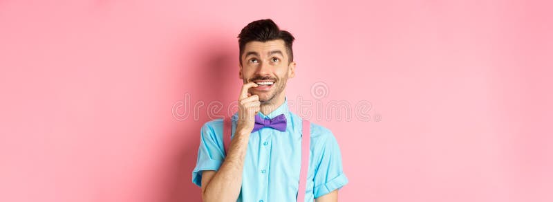 Image of Smiling Man Making Choice, Looking Dreamy and Happy Up, Biting ...