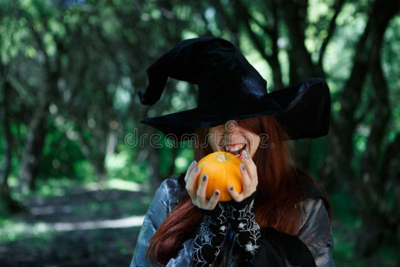 Image of Smiling Witch with Pumpkin Stock Image - Image of attire ...
