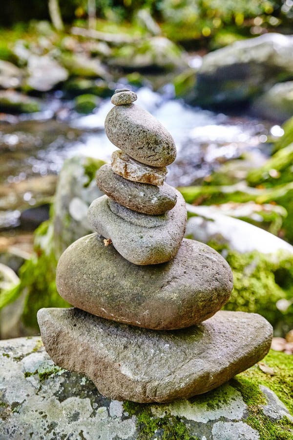 Stack of Smooth Rocks with a River in the Background Stock Image ...