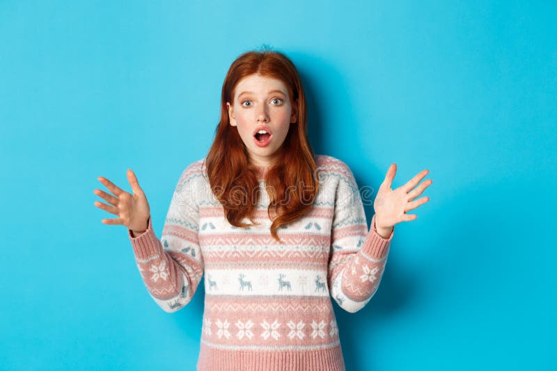 Image of Startled Redhead Woman Staring at Camera with Hands Spread ...