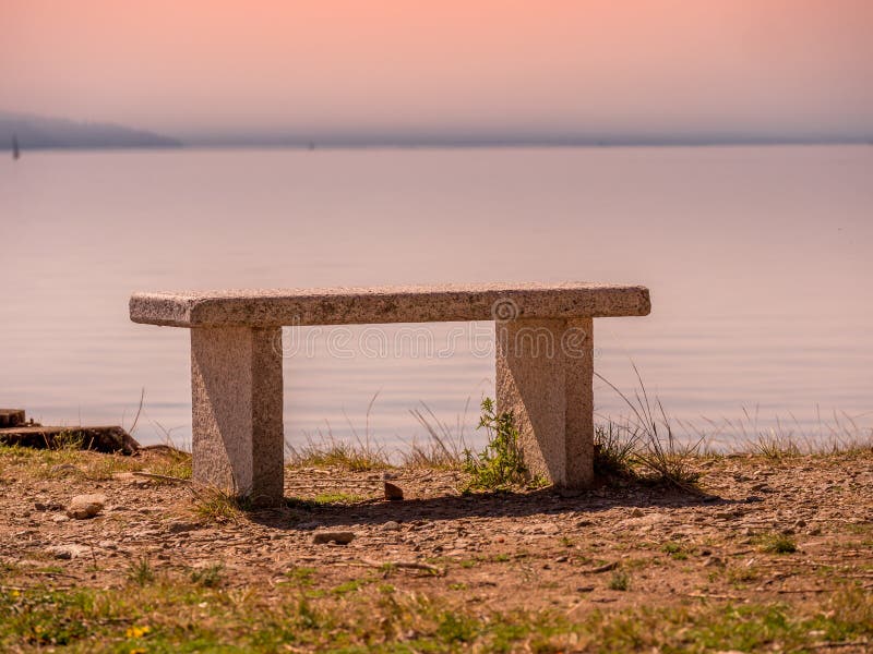 Image with Stone Bench in Front of a Lake with Sunset View Stock Image ...